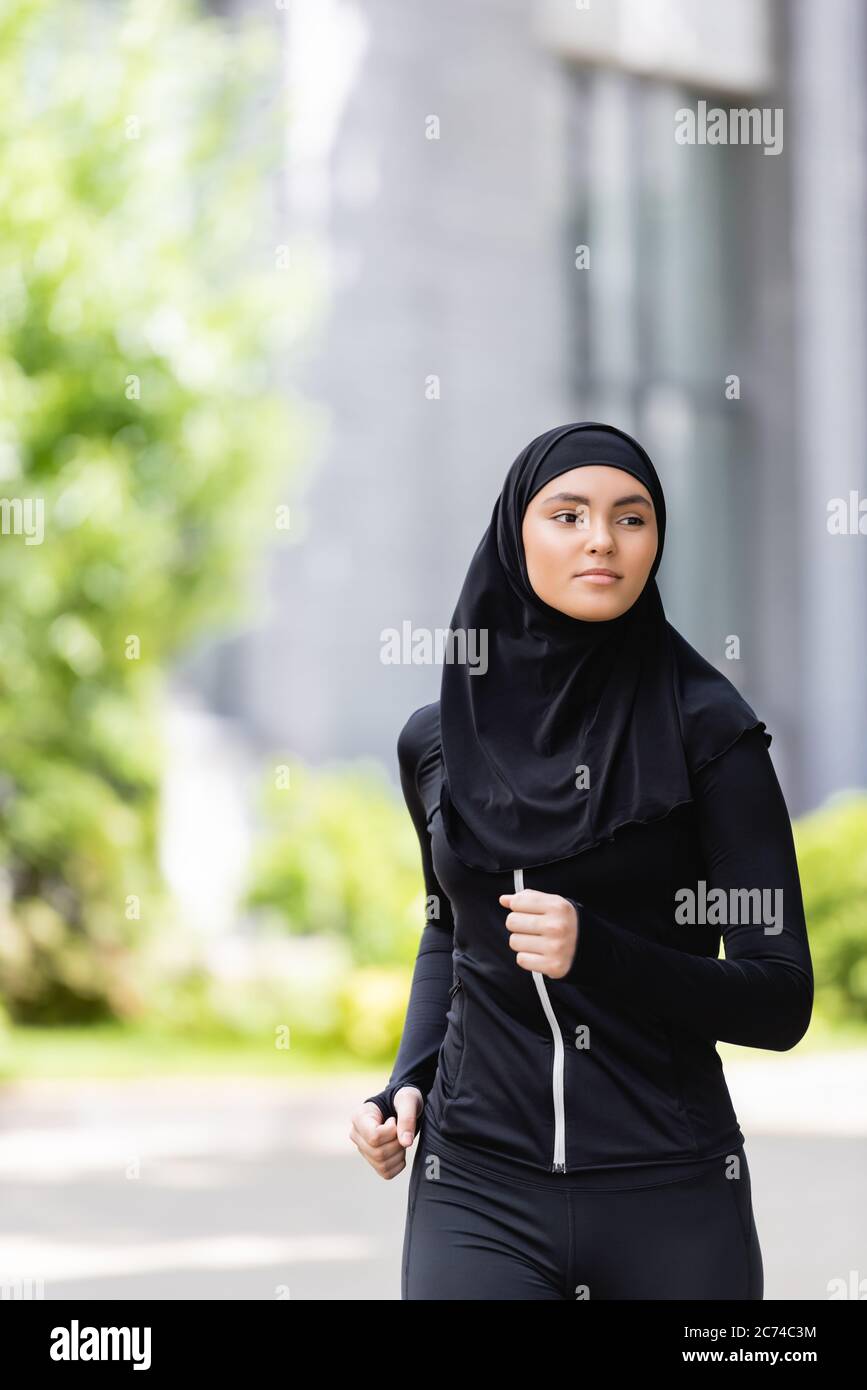 young arabian sportswoman in hijab running outside Stock Photo - Alamy