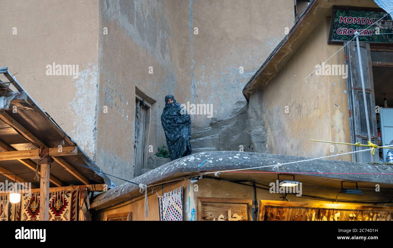 Masuleh, Iran - May 2019: Iranian old woman walking down the stairs in ...