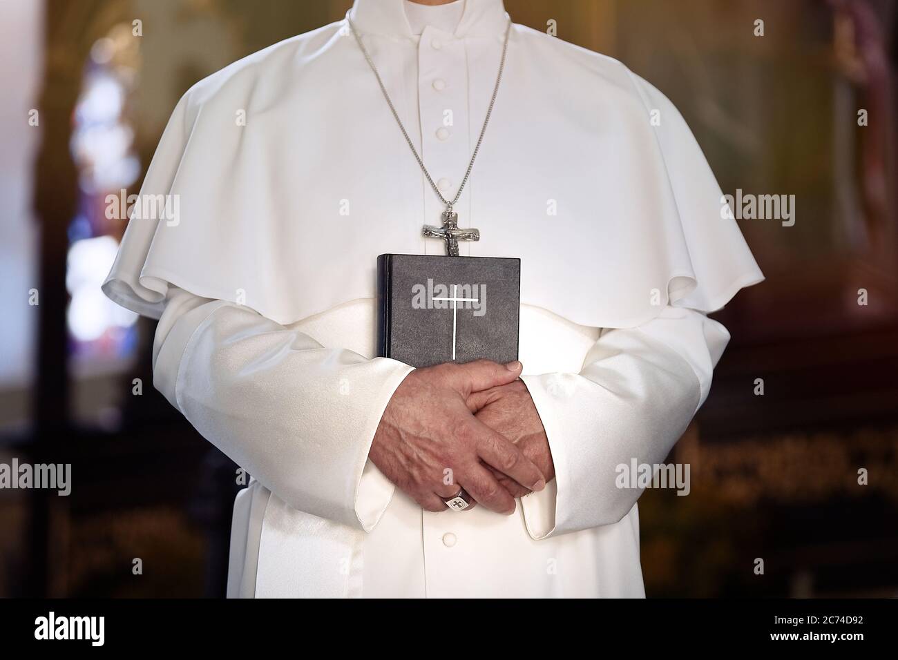 Catholic priest holding holy bible hi-res stock photography and images ...