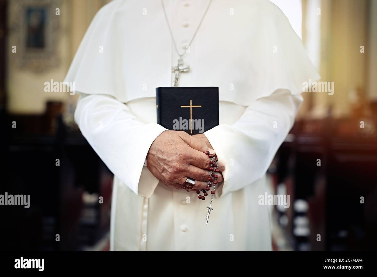Catholic priest holding holy bible hi-res stock photography and images ...