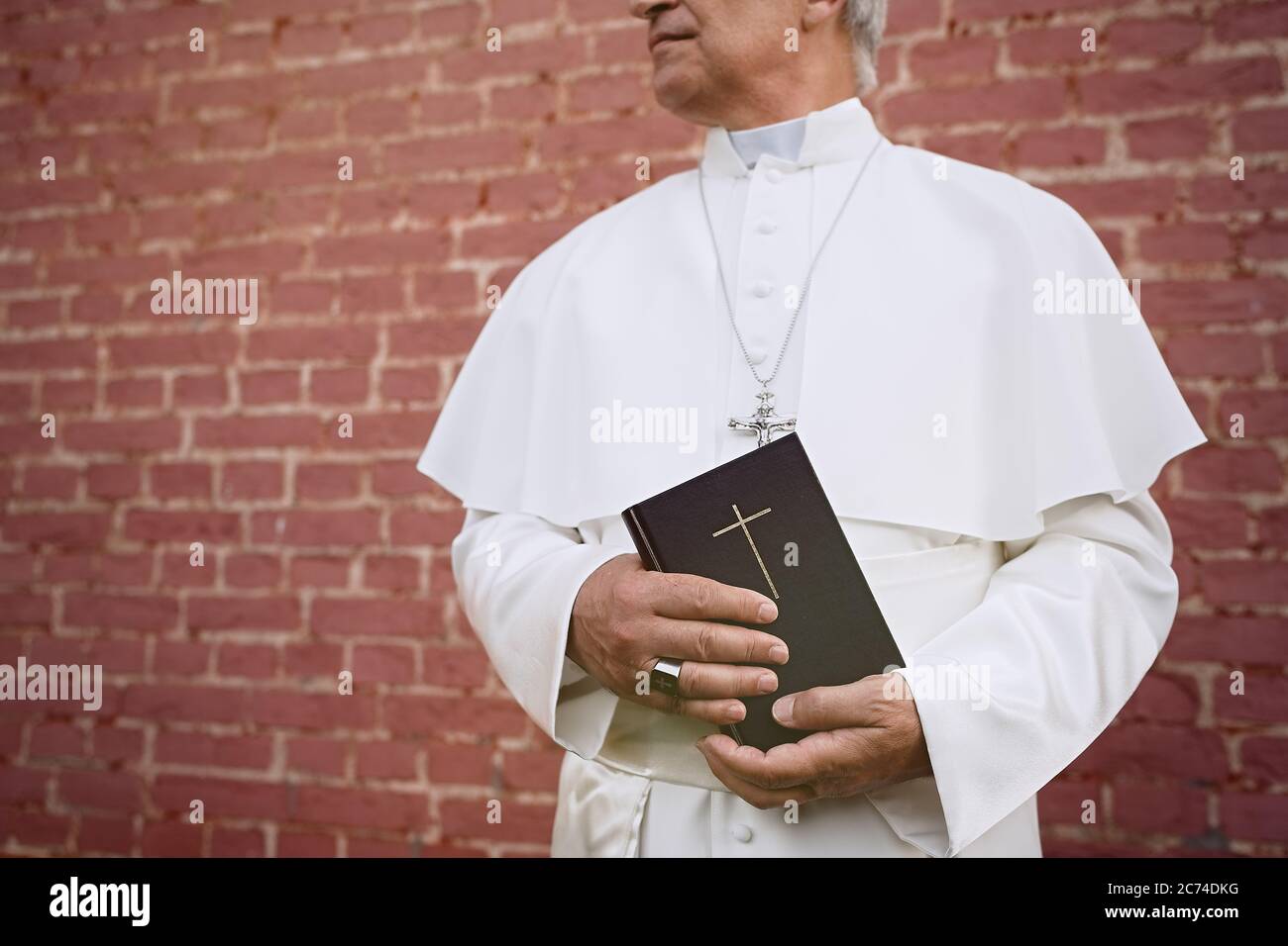 Priest holding book holy scripture hi-res stock photography and images ...