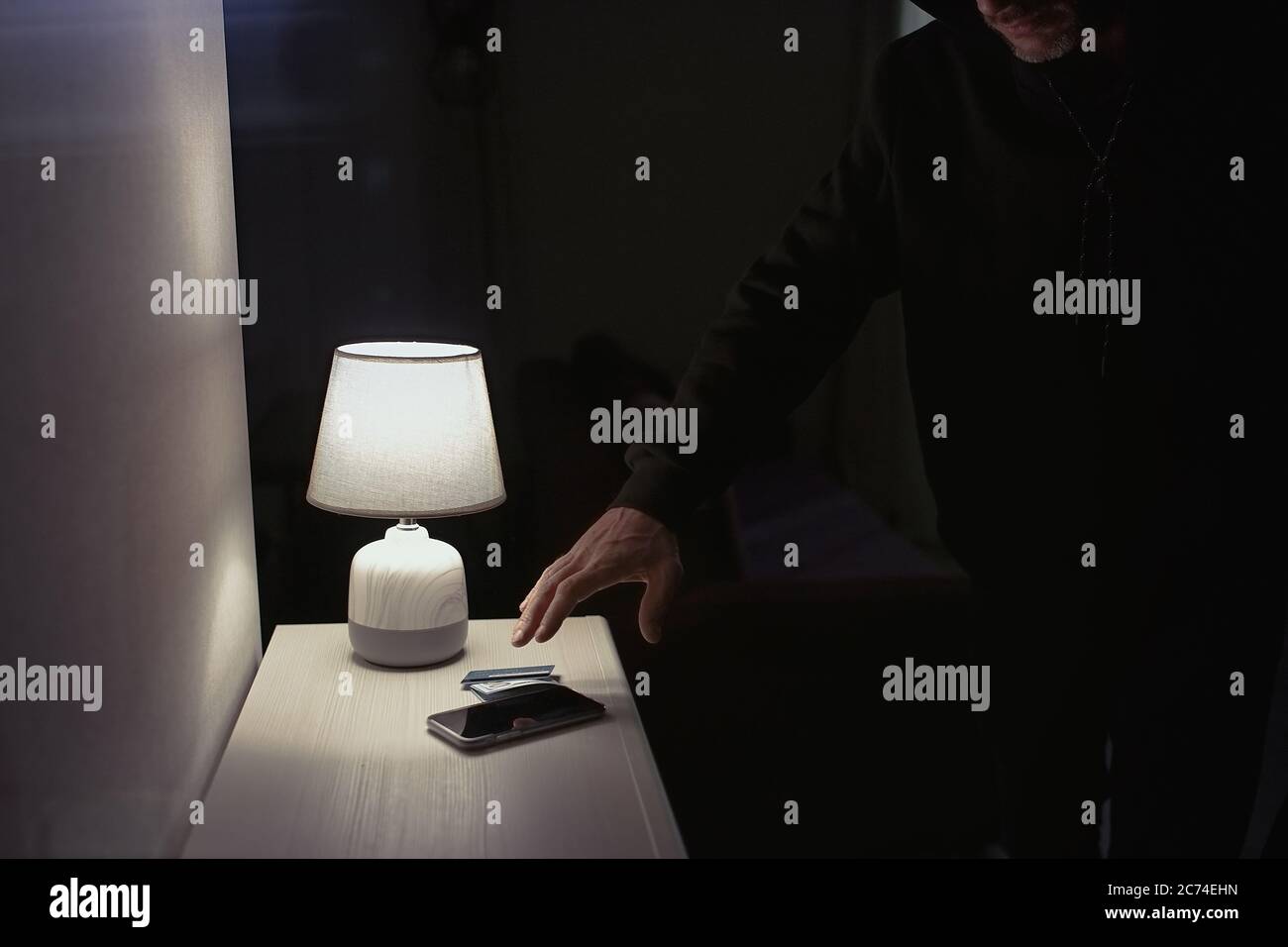 Robber in the hood inside the house at night Stock Photo - Alamy