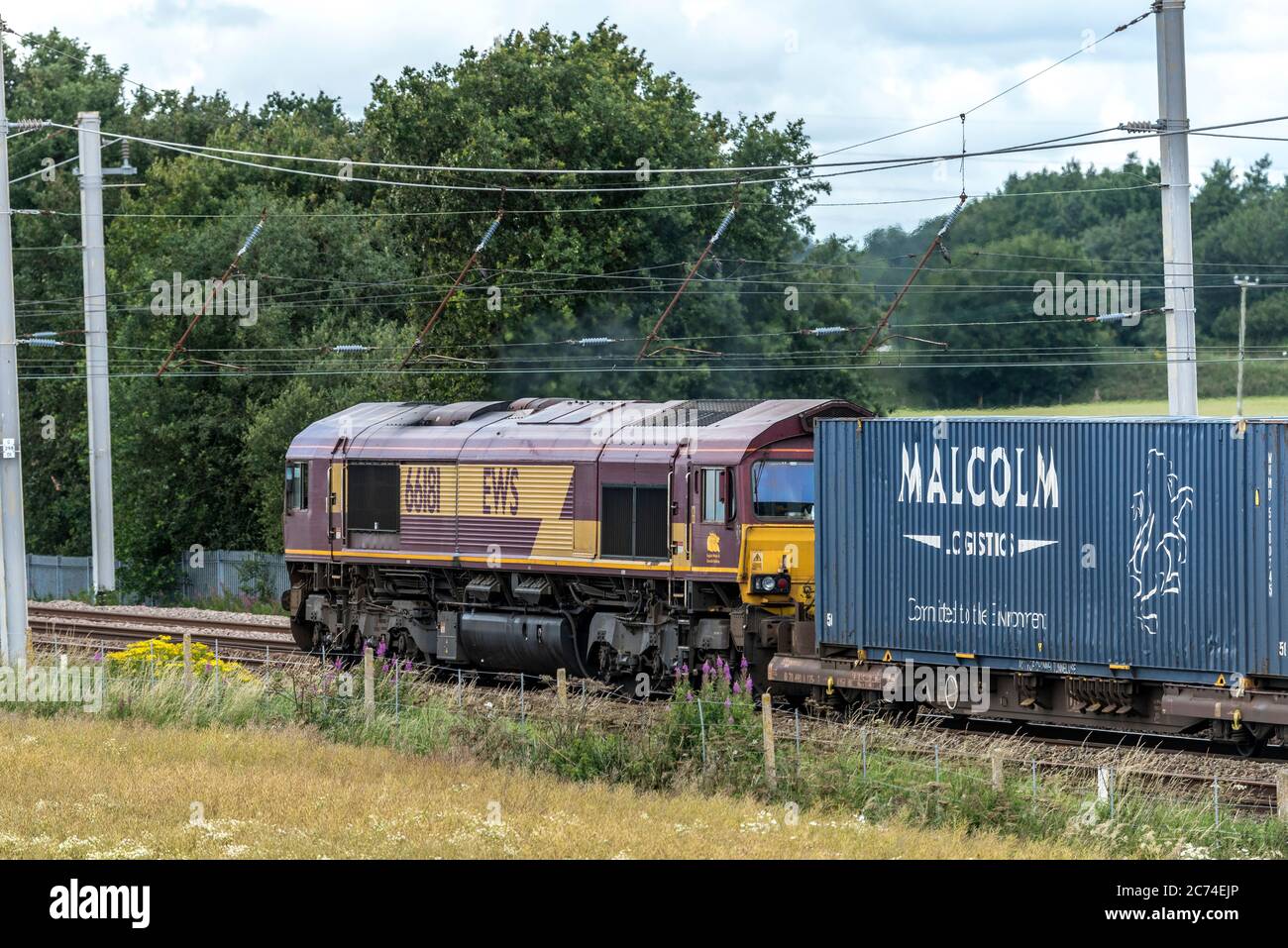 EWS freight train at Winwick on the West Coast Main line. Class 66 ...