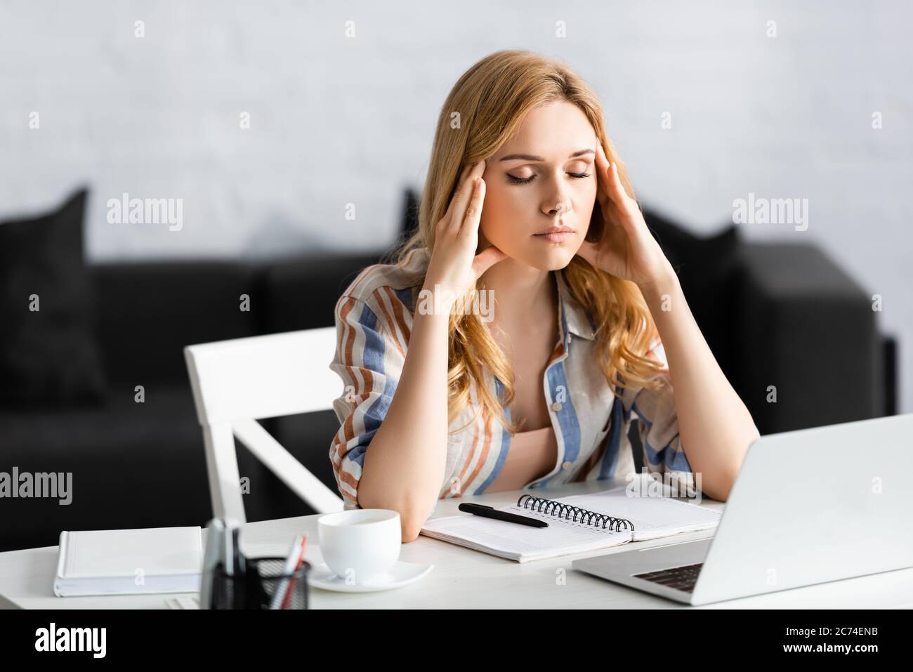 tired woman having headache at workplace at home Stock Photo - Alamy