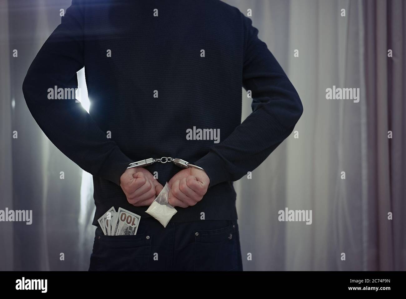 Handcuff behind back man hi-res stock photography and images - Alamy