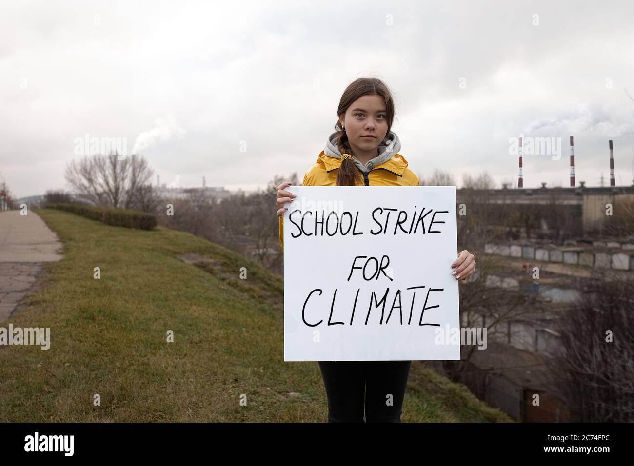 Teenager girl holding placard during global strike for climate change ...