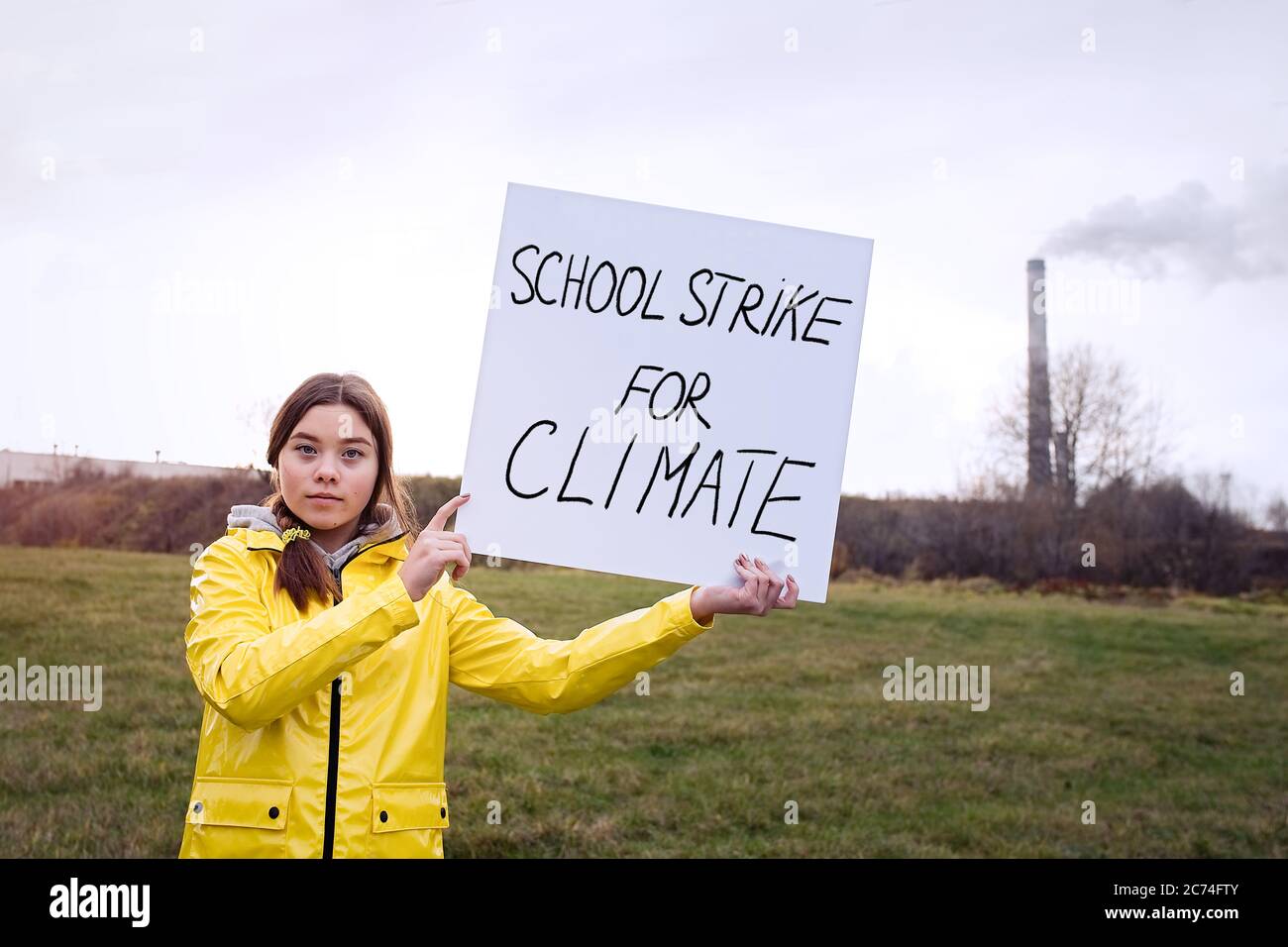 Teenager girl holding placard during global strike for climate change ...