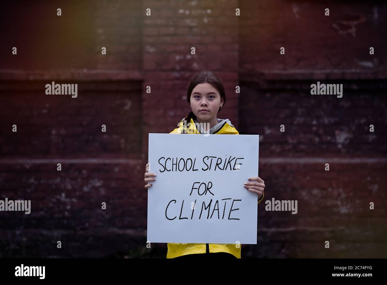 Teenager girl holding placard during global strike for climate change ...