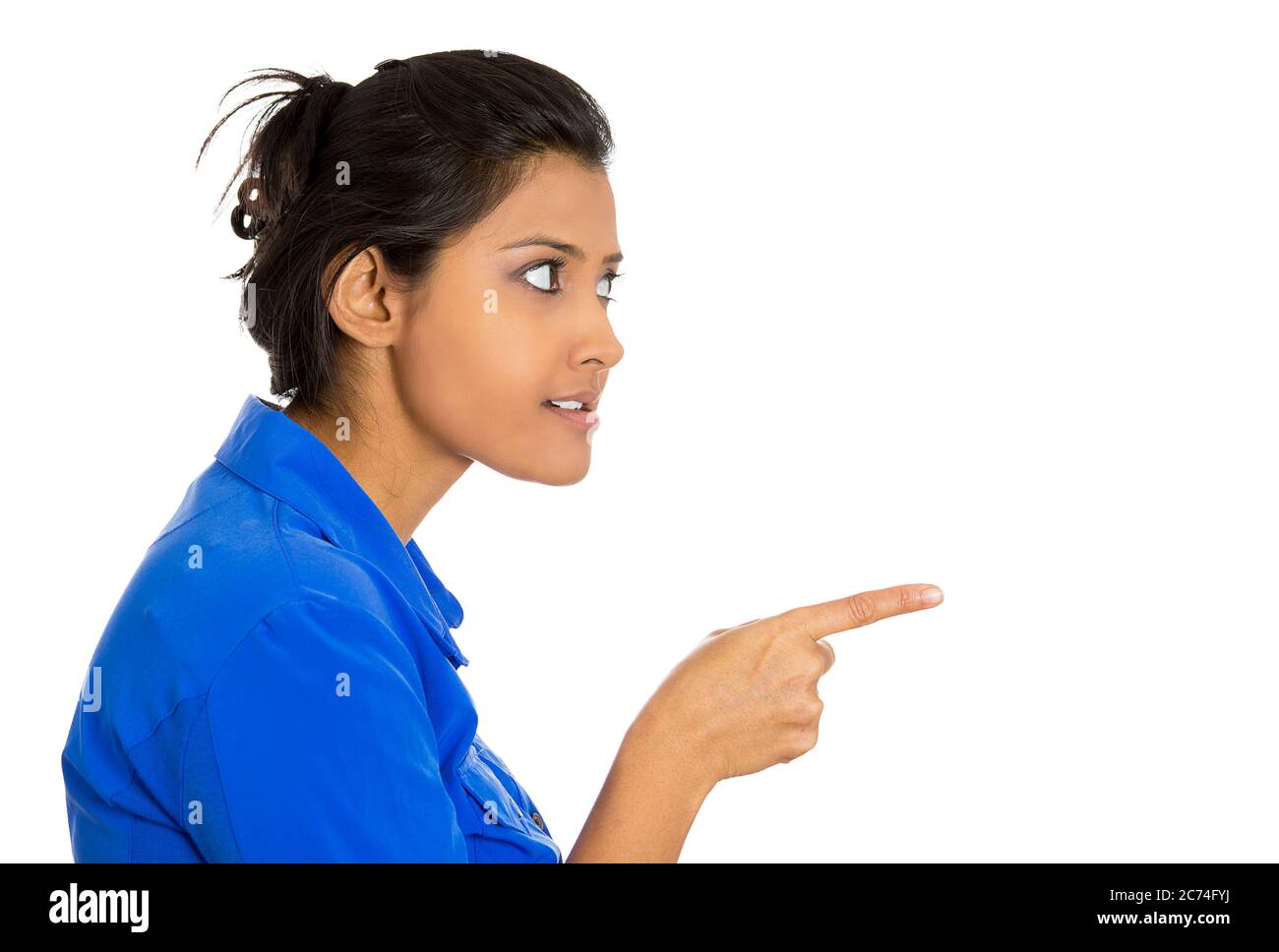 Side profile portrait of young unhappy, serious woman pointing at ...
