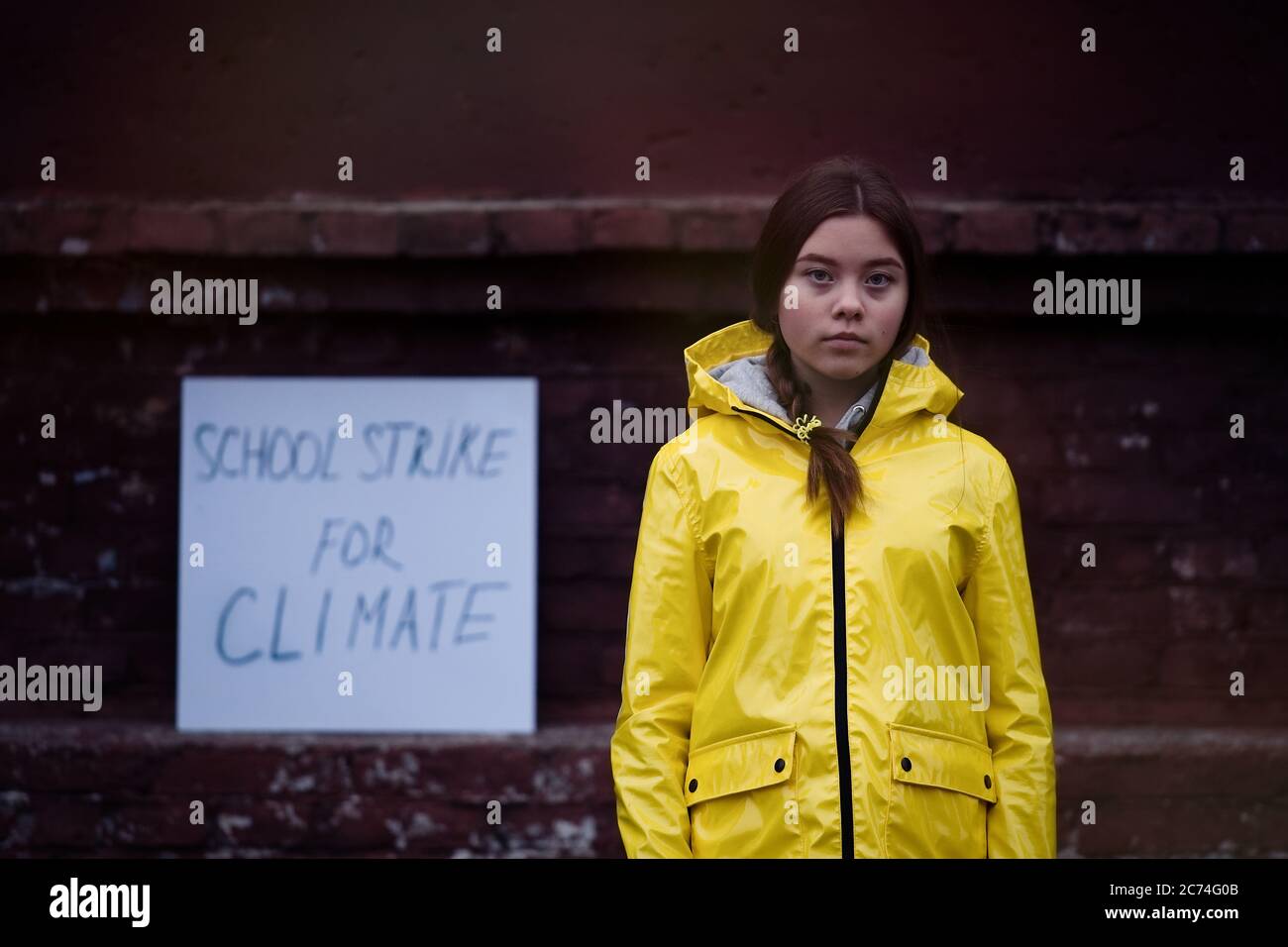 Teenager girl holding placard during global strike for climate change ...