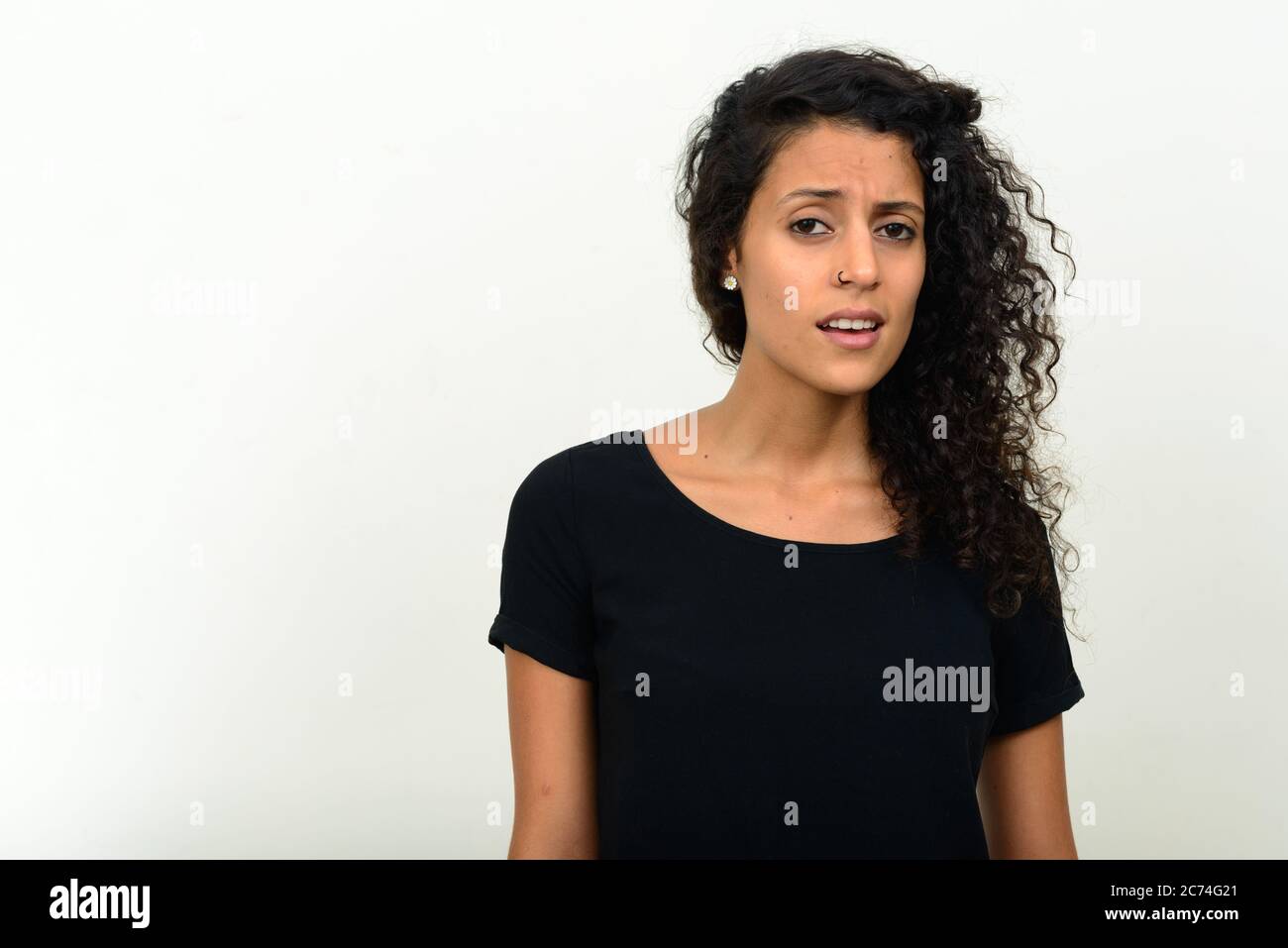 Portrait of young beautiful Hispanic woman with curly hair Stock Photo ...