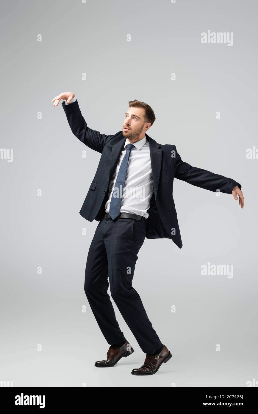 businessman marionette in suit posing with raised hands isolated on ...