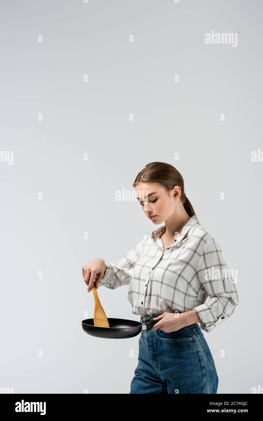 attractive girl posing like puppet with mop and frying pan isolated on ...