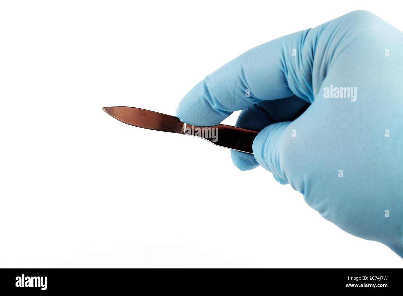 medical scalpel in the hand of a surgeon, white background, close-up ...