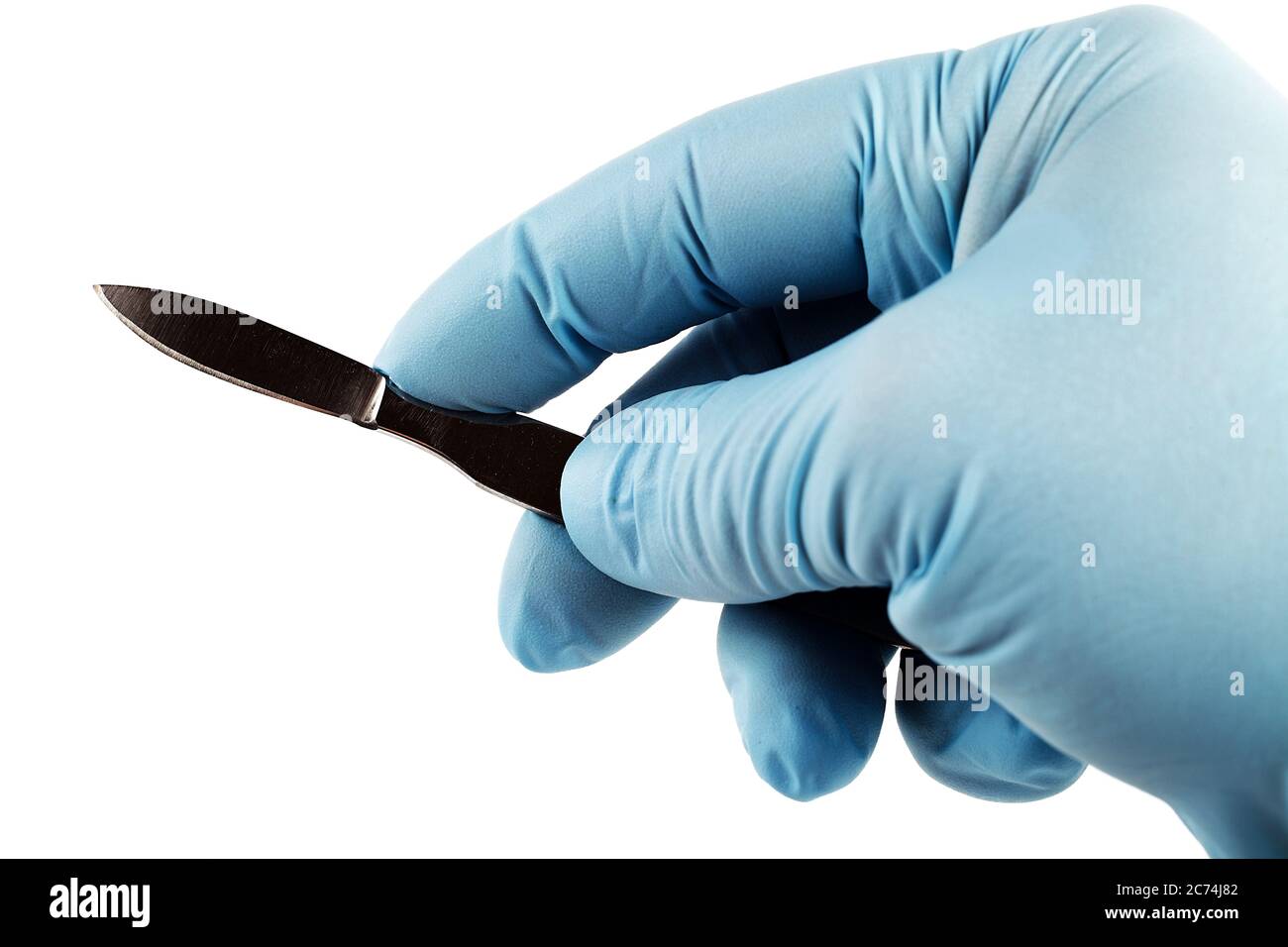 medical scalpel in the hand of a surgeon, white background, close-up ...