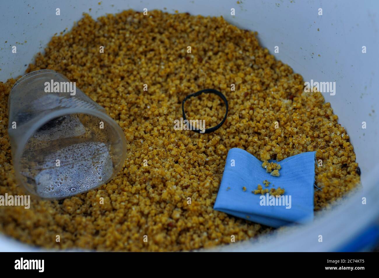 fish food in a plastic bucket Stock Photo - Alamy