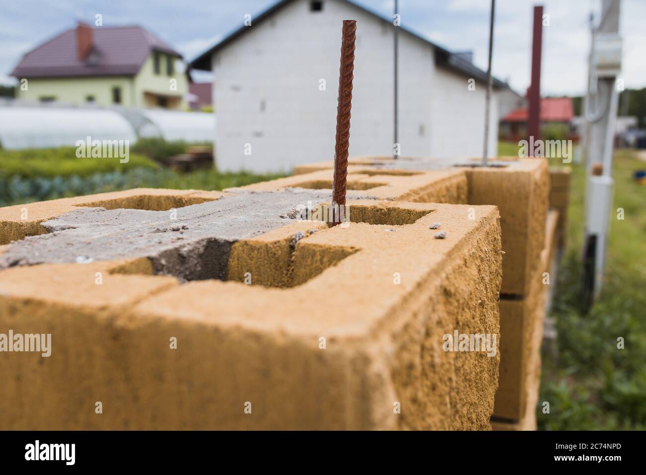 Stone blocks of a fence on a concrete strip foundation - supports for a ...