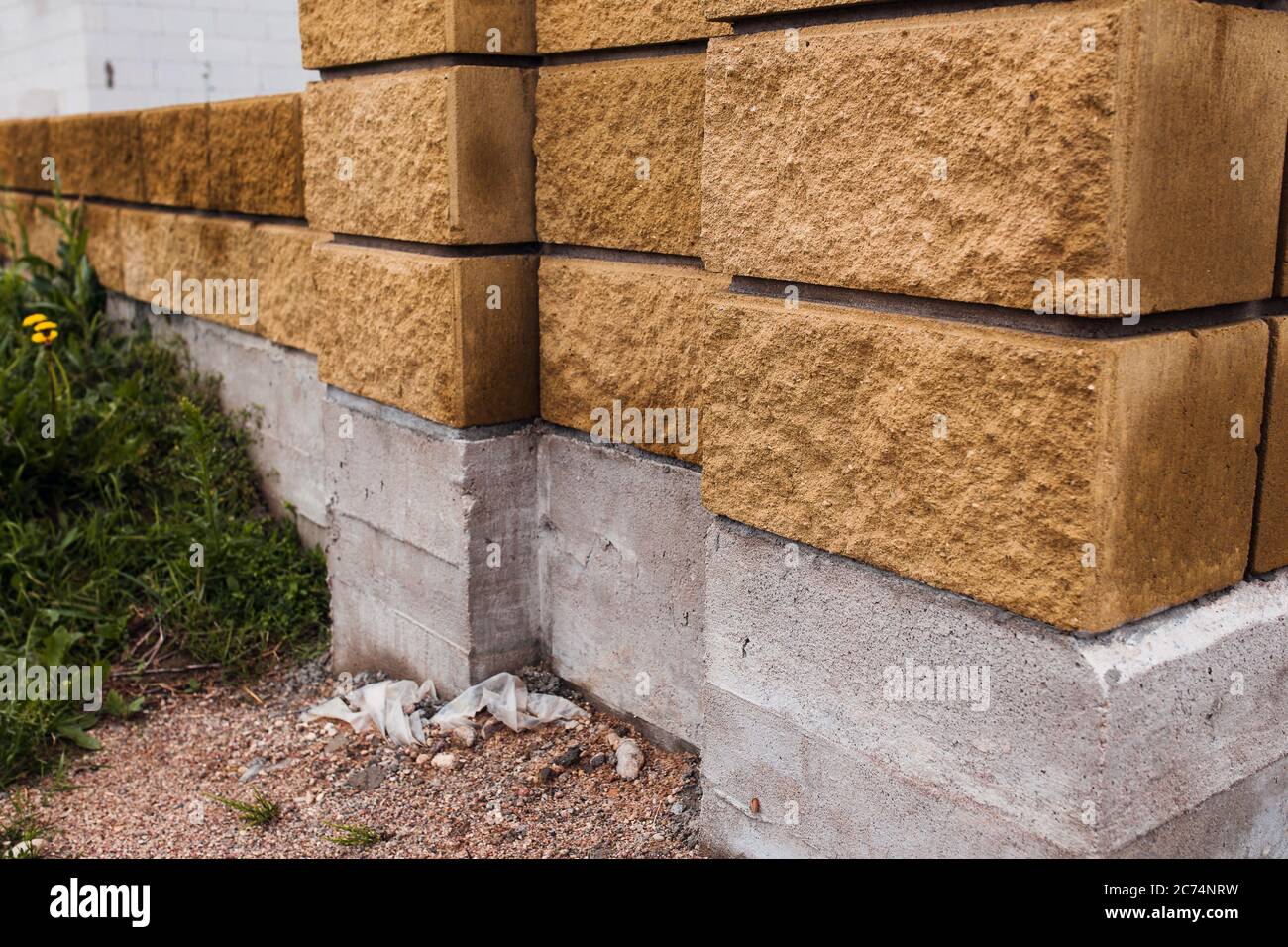 Stone blocks of a fence on a concrete strip foundation - supports for a ...