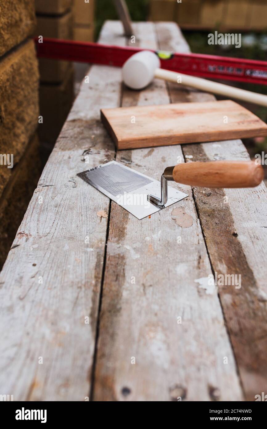 Work tools of a professional bricklayer - mallet, trowel and embroidery ...