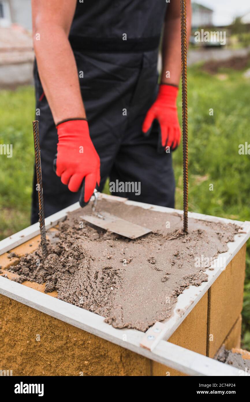 Hard work of a builder - a professional bricklayer skillfully builds ...