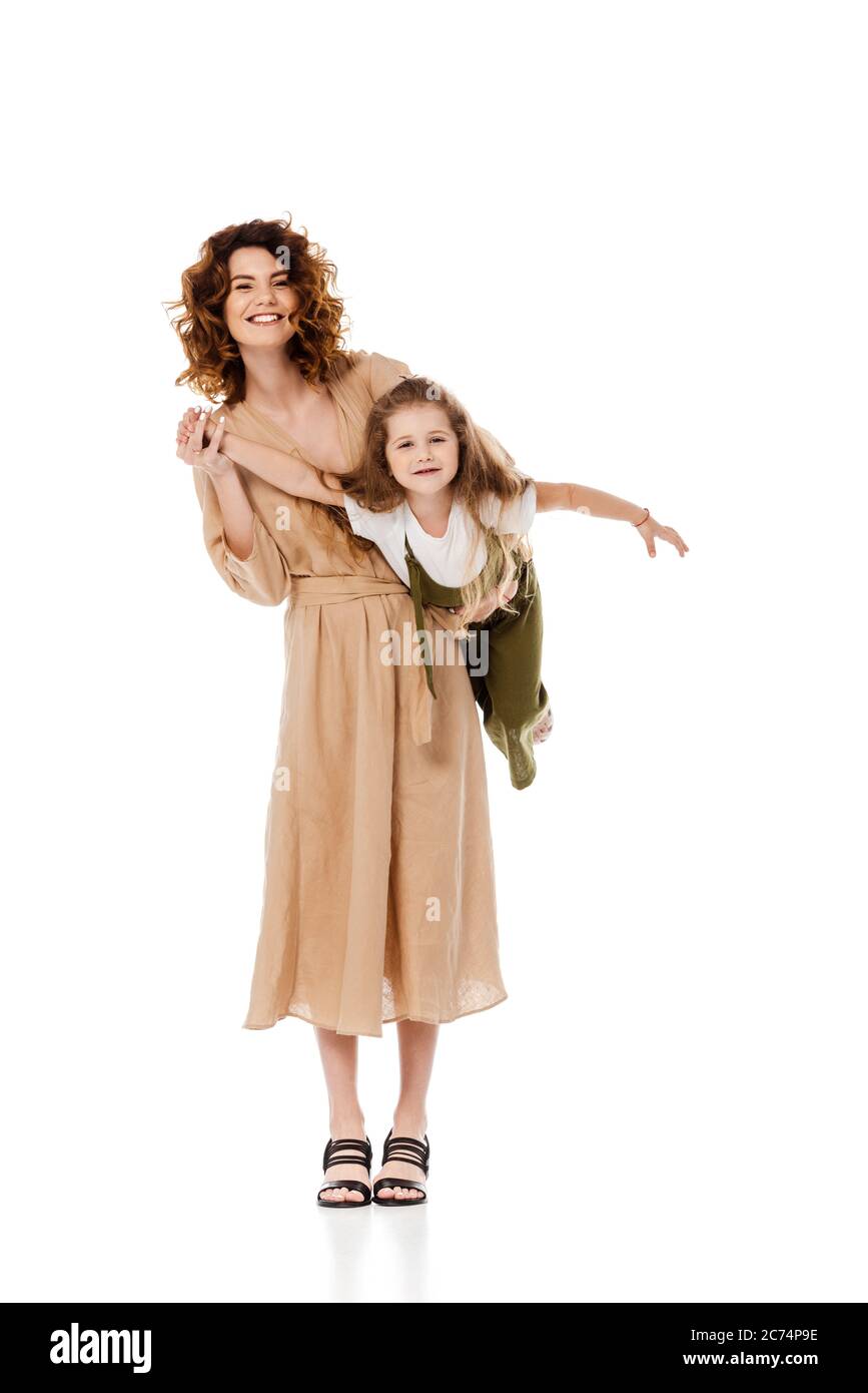 cheerful mother holding in arms daughter isolated on white Stock Photo ...