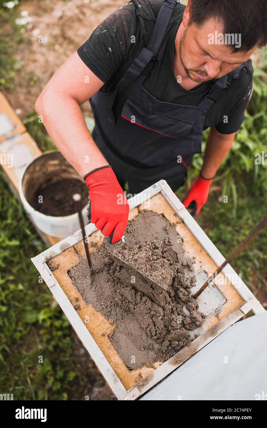 Professional masonry of building concrete blocks with filling empty ...