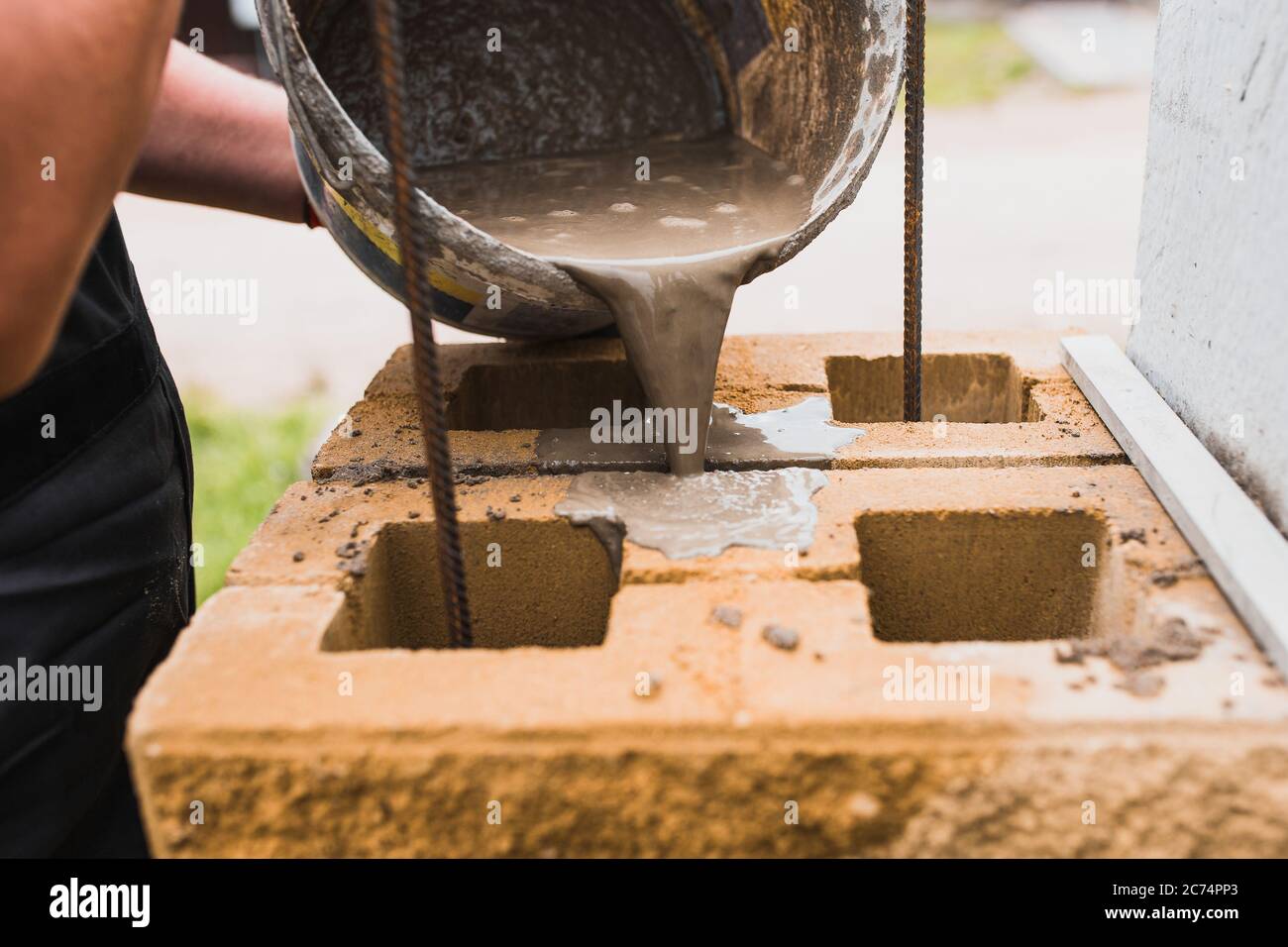 Professional masonry of building concrete blocks with filling empty ...
