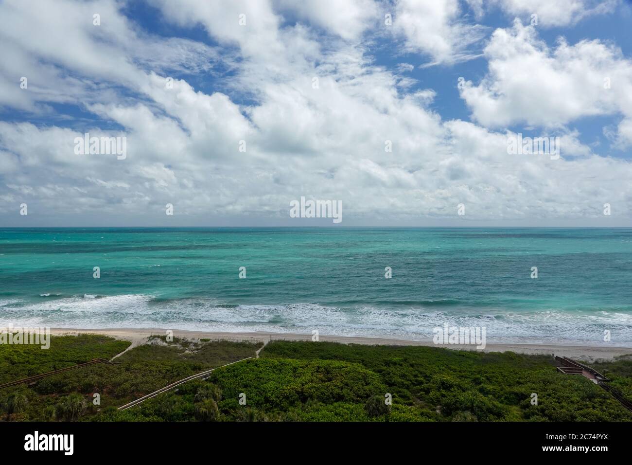An aerial view of the turquoise blue water of the Atlantic Ocean on a ...