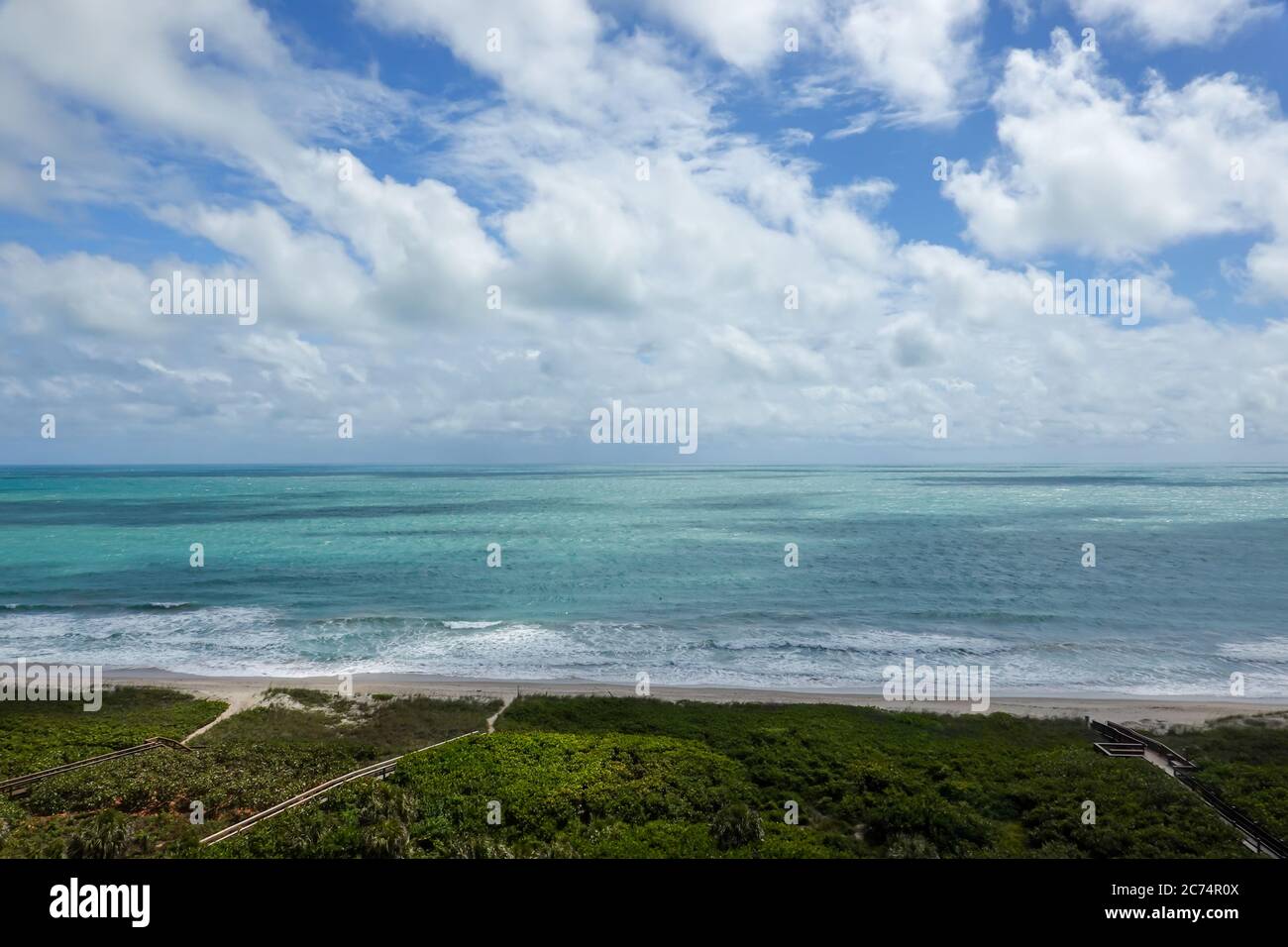 An aerial view of the turquoise blue water of the Atlantic Ocean on a ...
