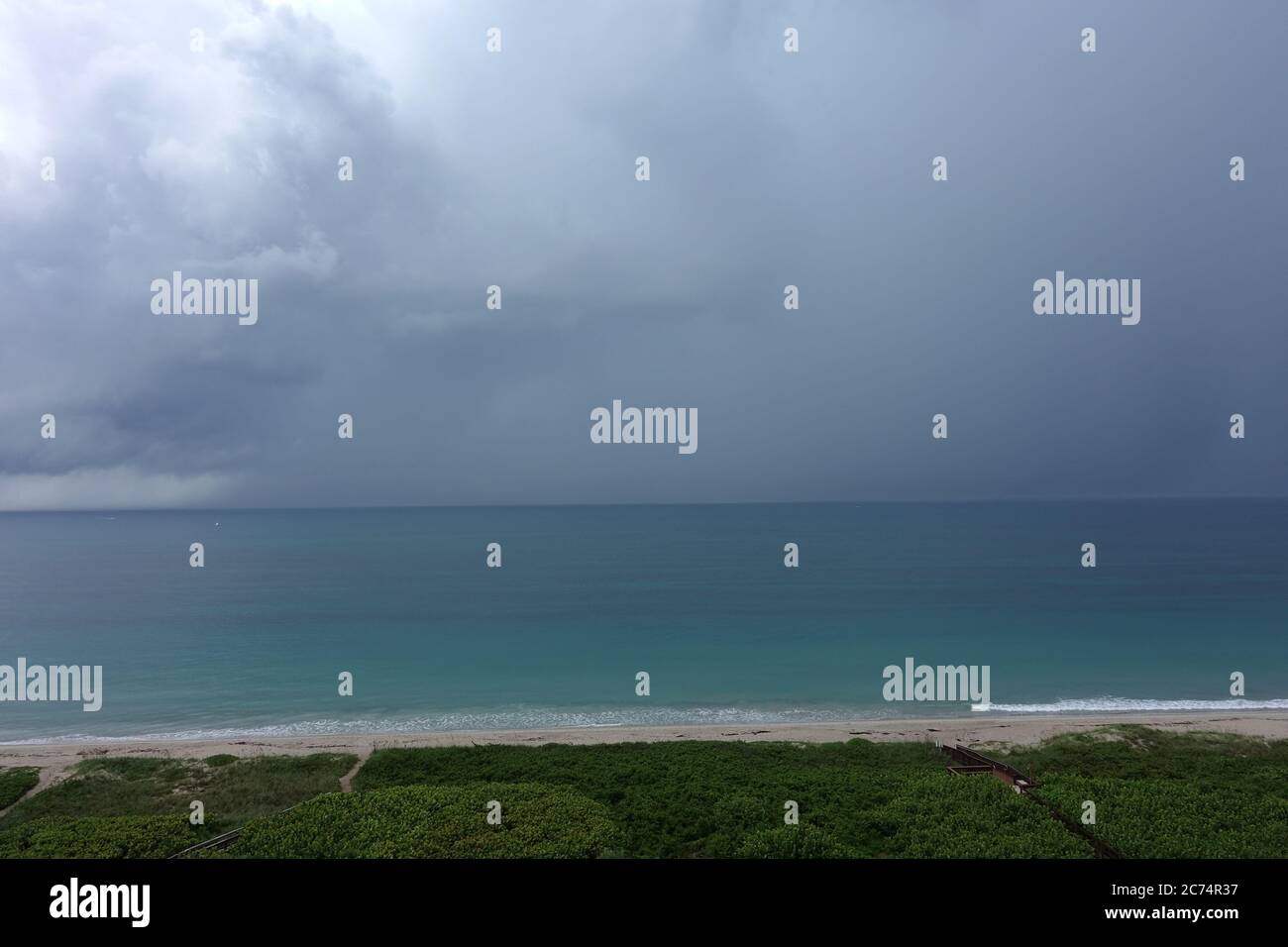 A storm over the colorful Atlantic Ocean with large dark clouds Stock ...