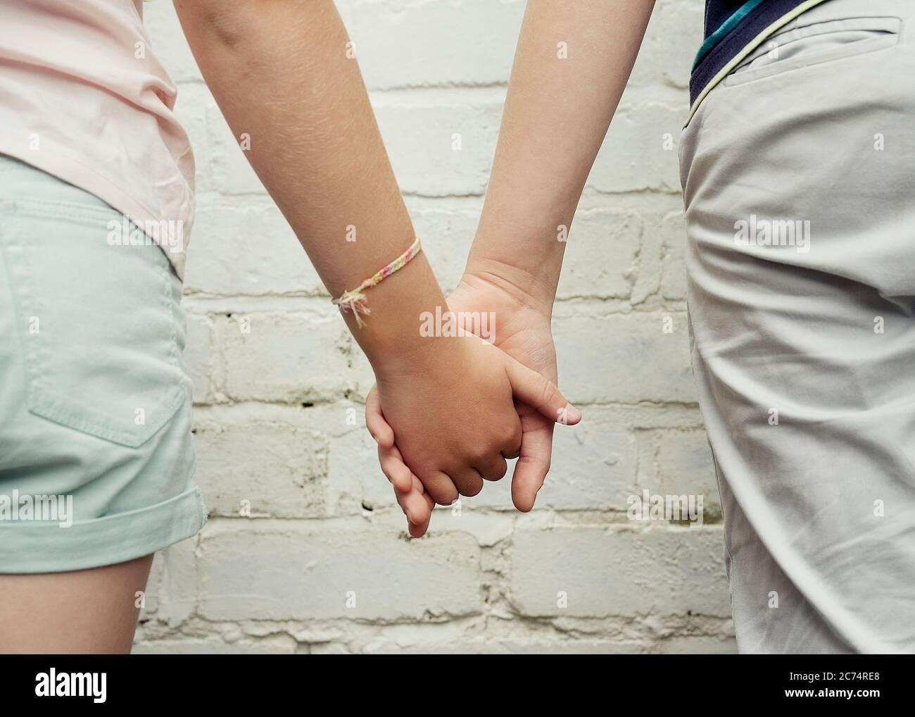 Two friends holding hands hi-res stock photography and images - Alamy
