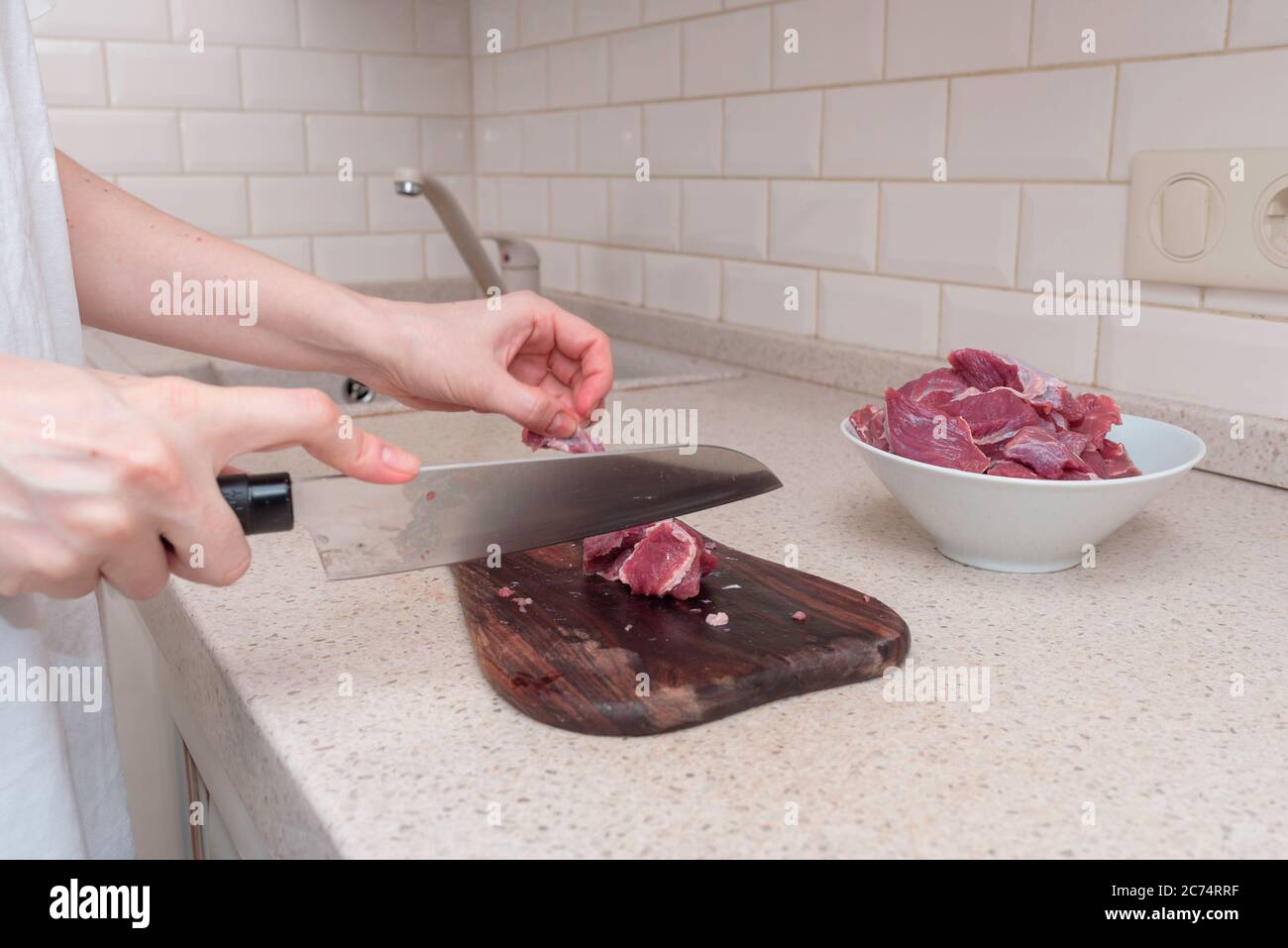 Chef cutting the meat on a wooden board Stock Photo - Alamy