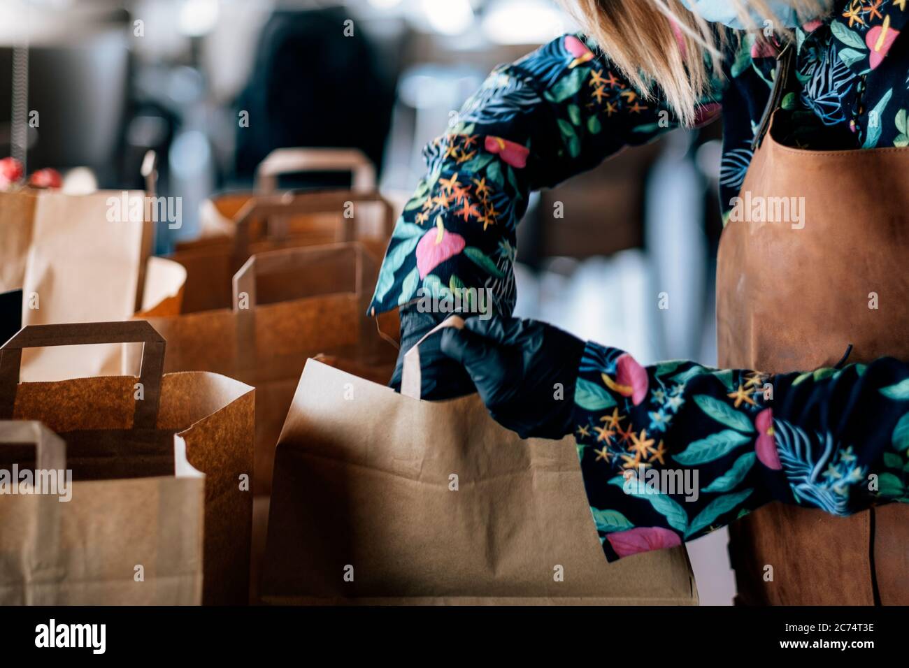woman preparing delivery food inside takeaway restaurant - Worker ...