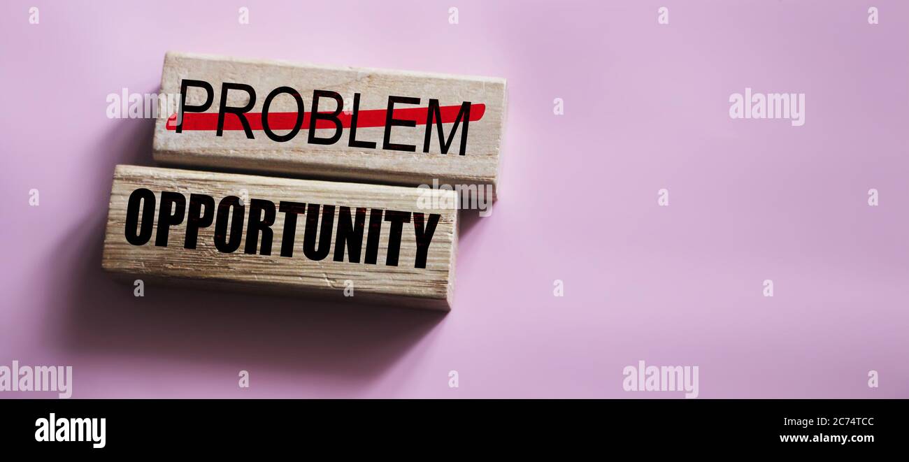 Problem crossed out and opportunity on wooden blocks. Business startup ...