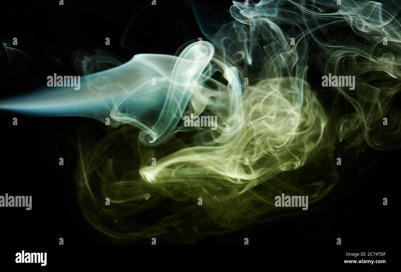 Abstract smoke swirls yellow color on black background. Elegant ...