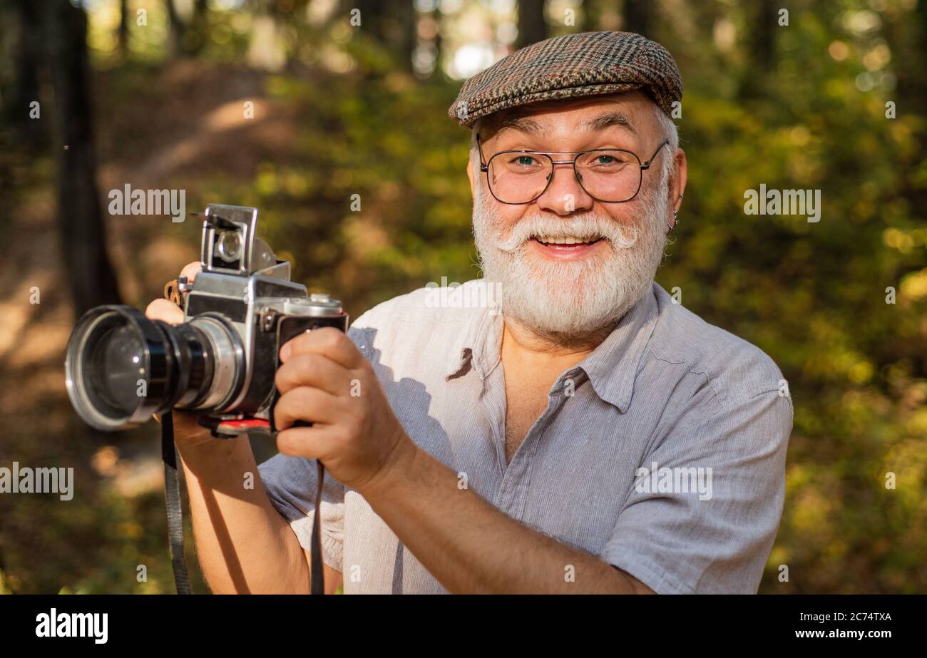 Vintage camera. Old man shoot nature. Professional photographer. Make ...