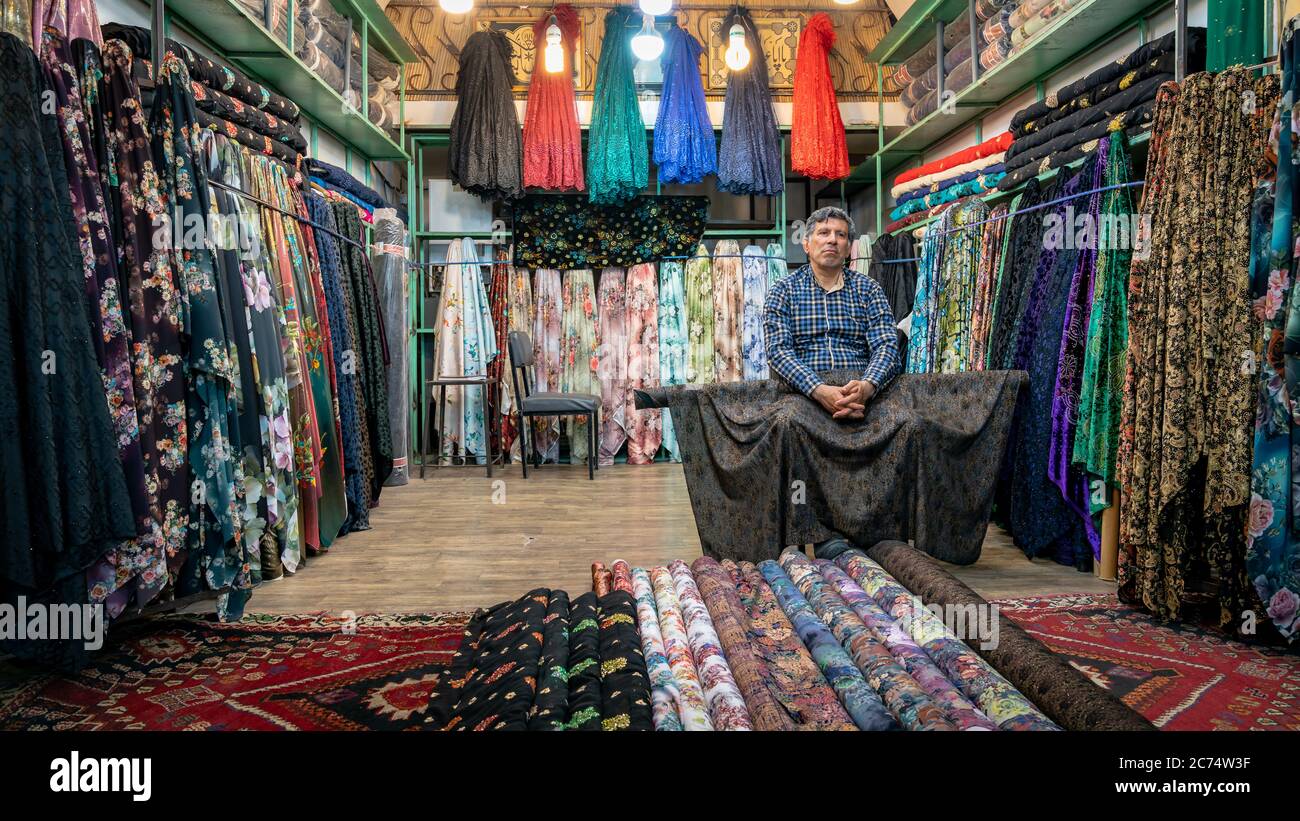 Isfahan, Iran - May 2019: Iranian man selling textiles in in his small ...