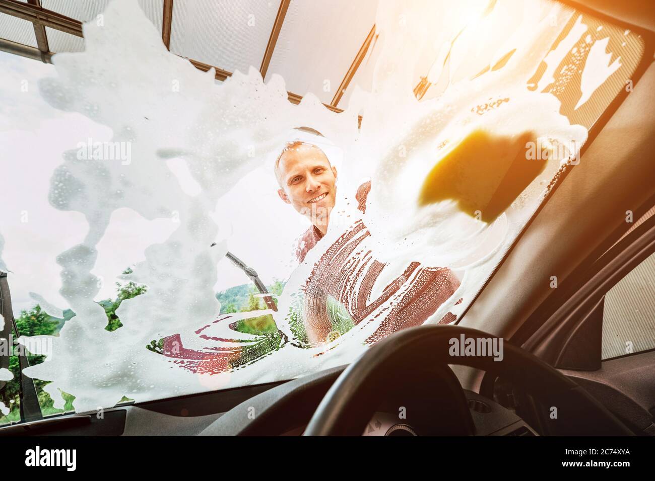 Young man washing windows hi-res stock photography and images - Alamy