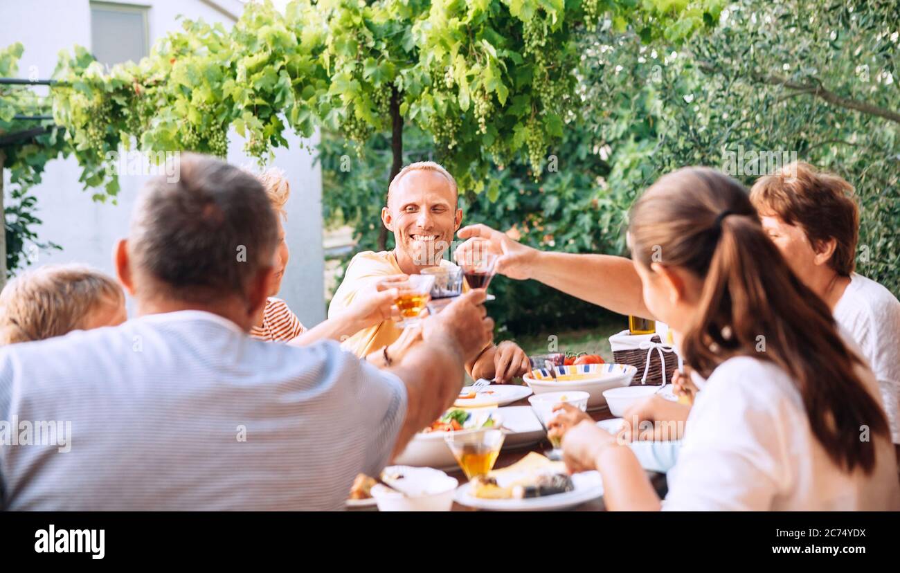 Family have dinner in summer garden Stock Photo - Alamy