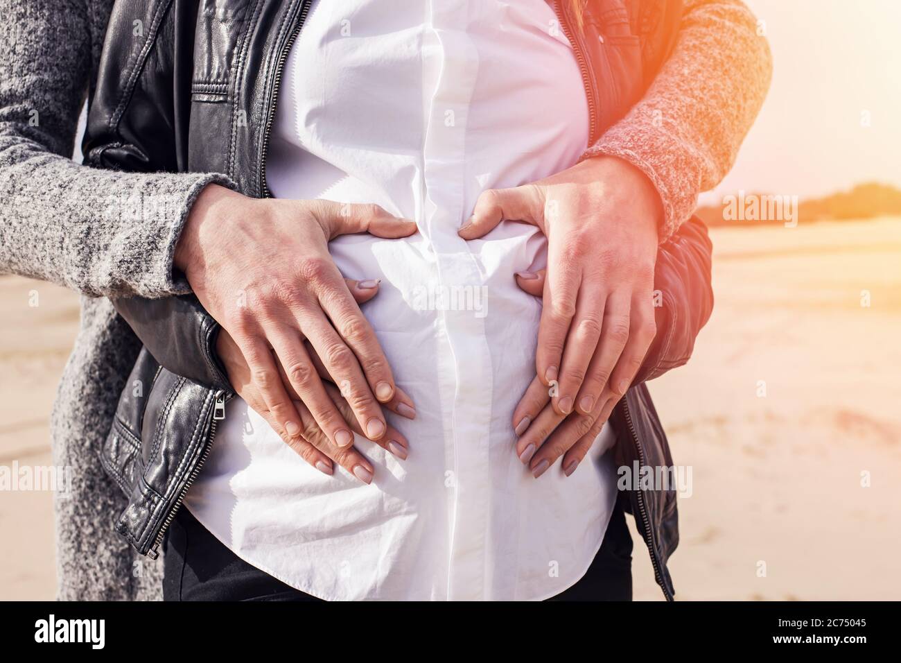 Pregnancy mom dad hugging belly hi-res stock photography and images - Alamy