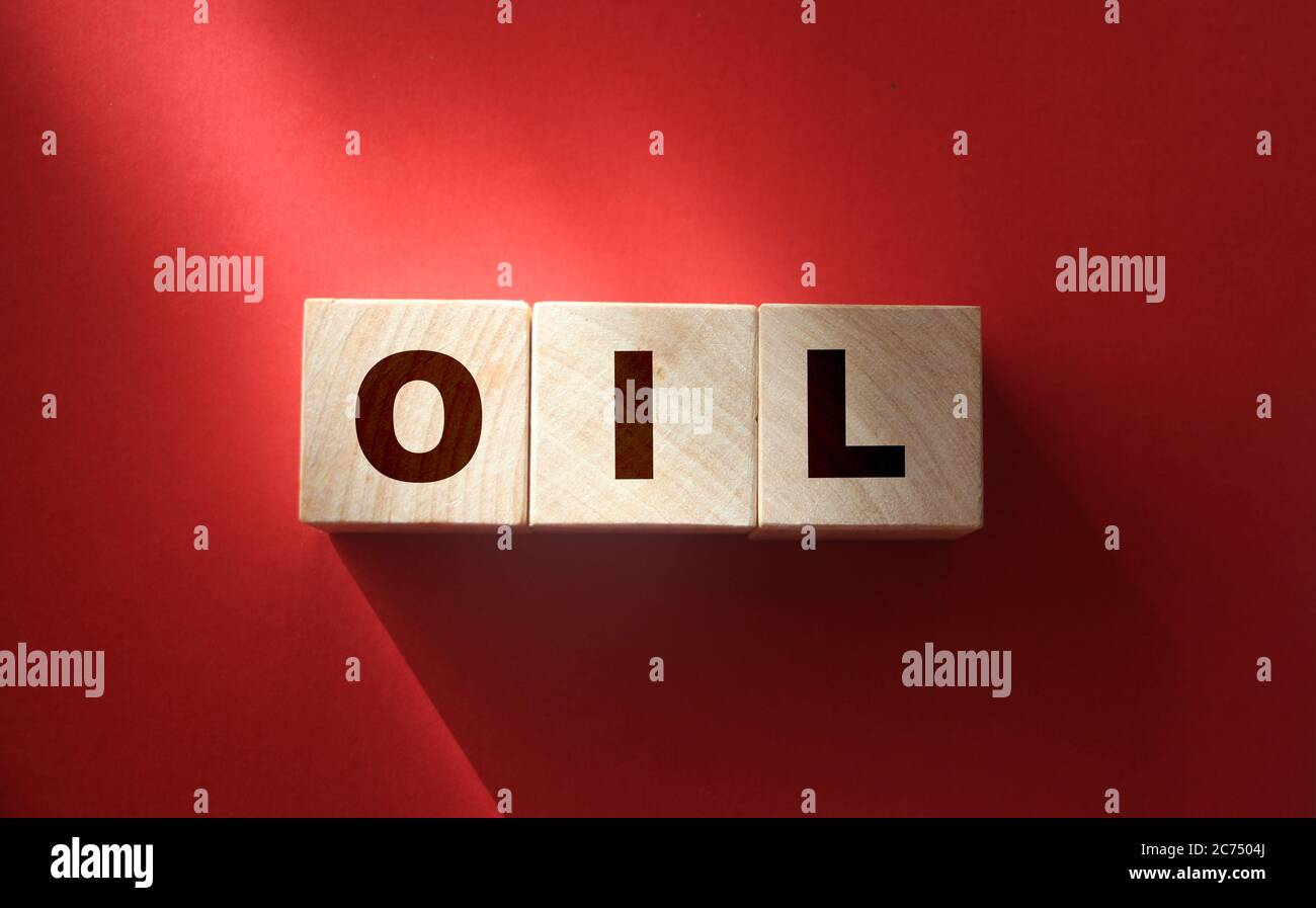 word OIL on cube blocks on red. World Economics business concept Stock ...