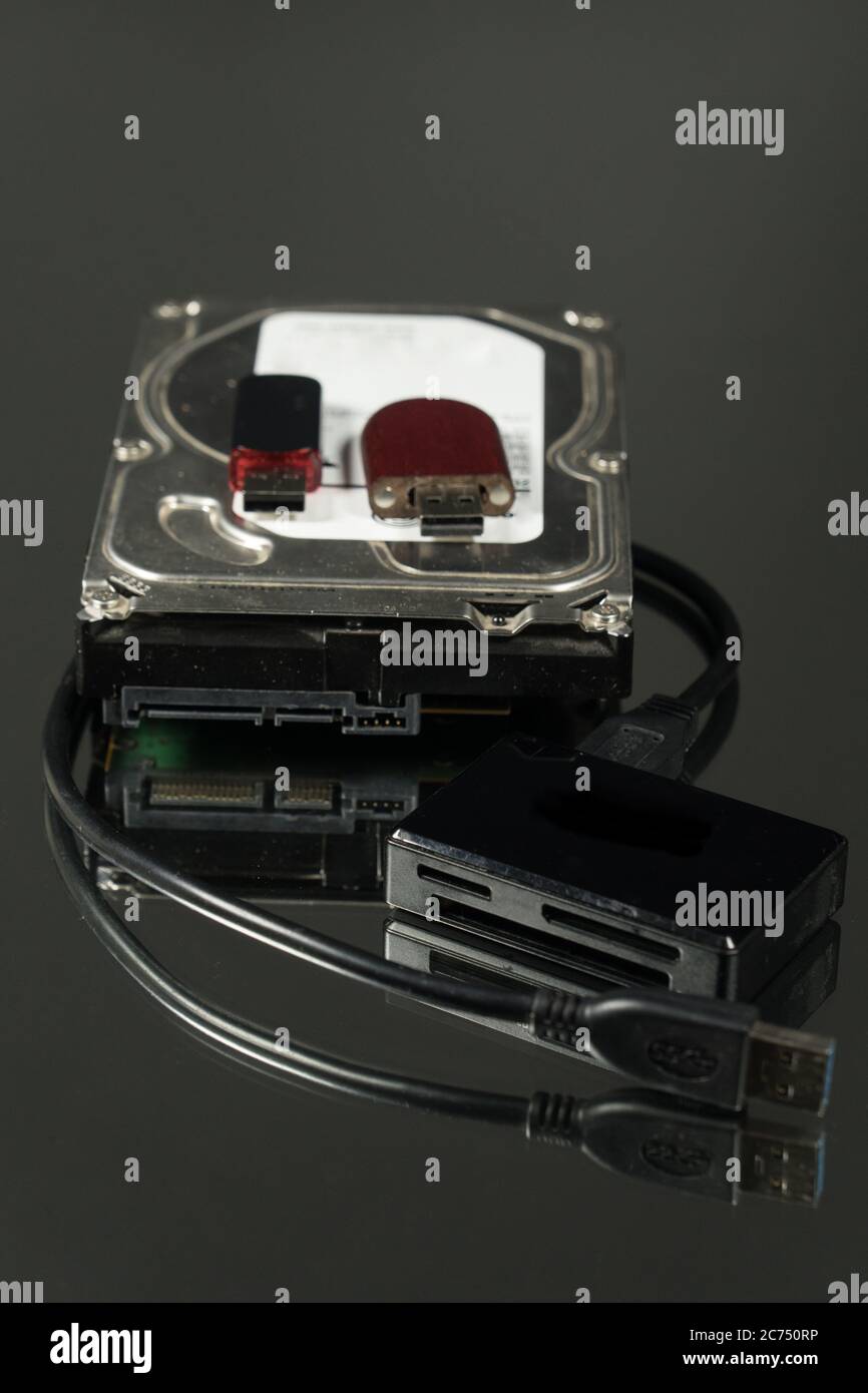 Universal card reader and hard drive isolated on black background Stock ...