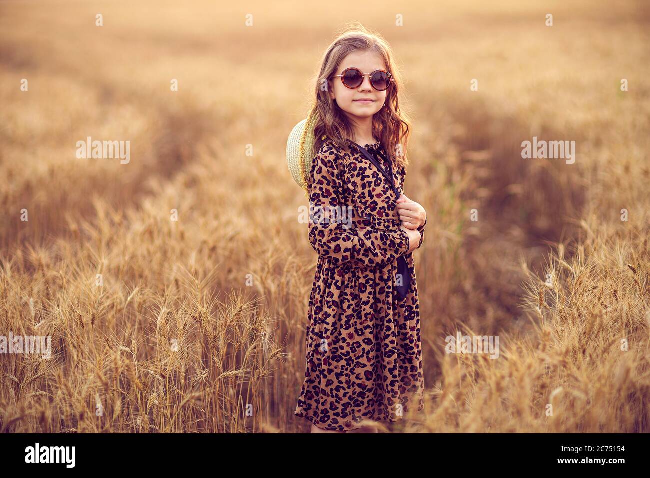 Fashion photo of a little girl in leopard print dress, sunglasses and ...