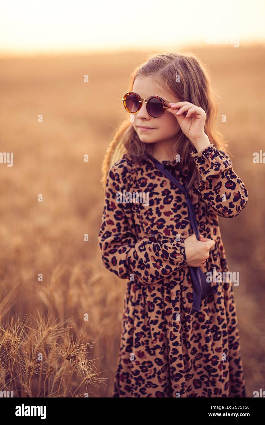 Fashion photo of a little girl in leopard print dress, sunglasses and ...