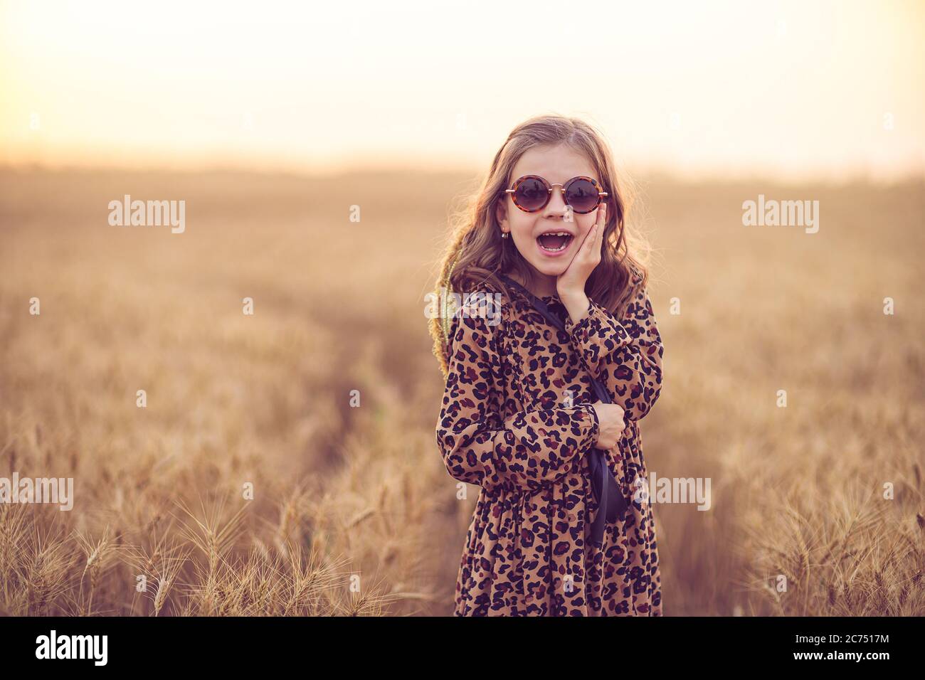 Fashion photo of a little girl in leopard print dress, sunglasses and ...