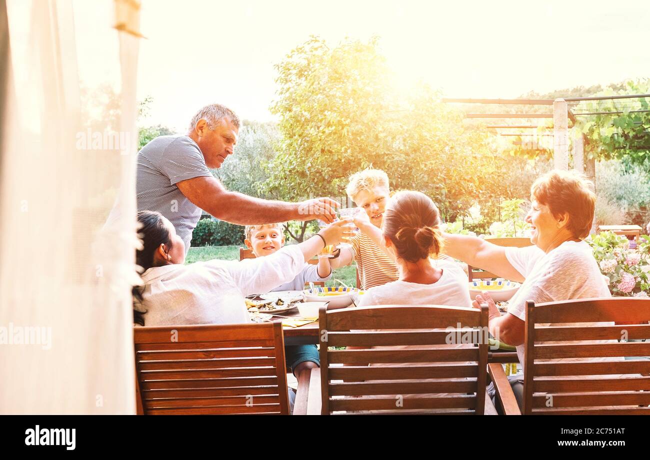 Three generations one family have dinner in summer garden Stock Photo ...