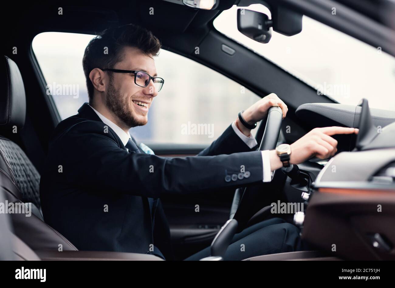 Man In Glasses Sitting In New Auto Checking Dashboard Stock Photo - Alamy