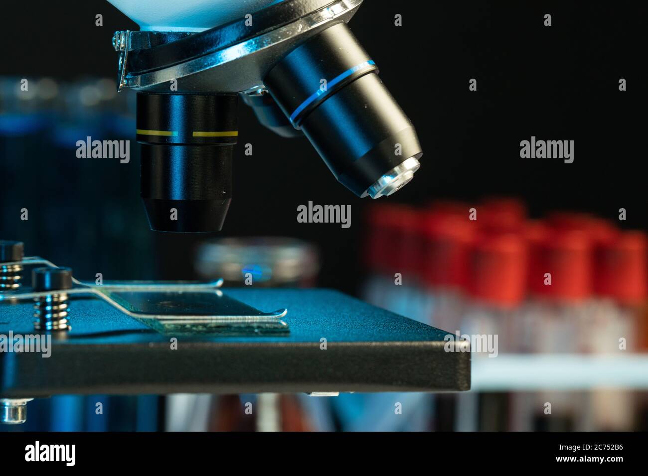 Microscope with lenses close up against dark background Stock Photo - Alamy