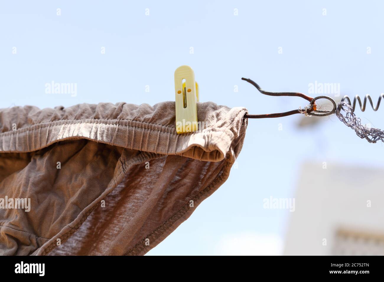 Freshly washed and drying clothes out of linen cloth Stock Photo - Alamy