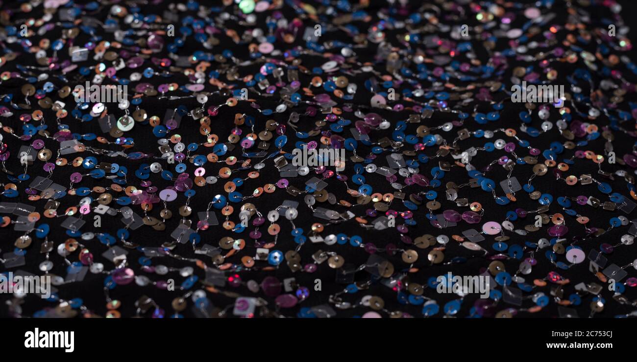 Texture of black cloth with colorful sequins. Close-up Stock Photo - Alamy